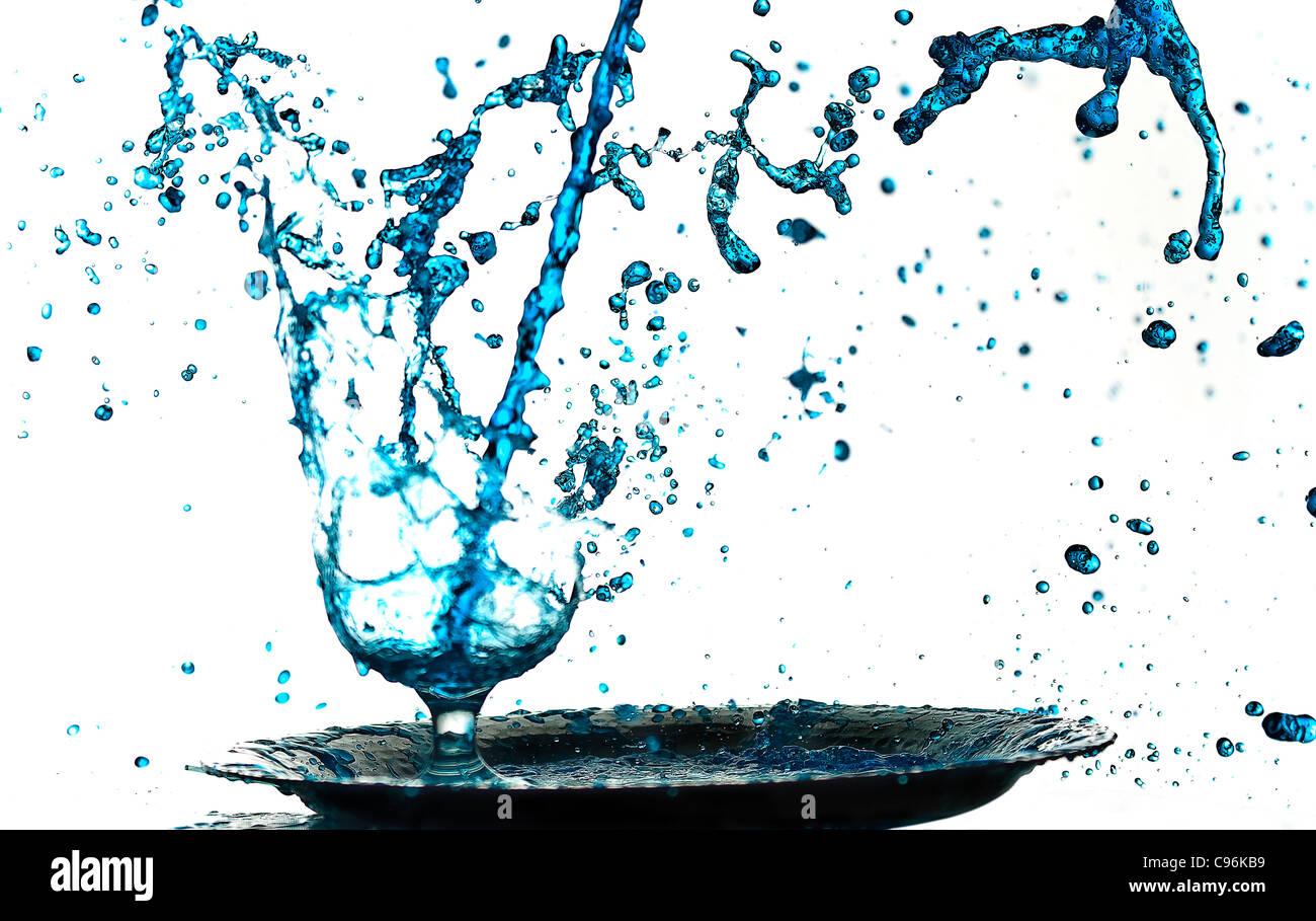 Splattering blue liquid from a snifter Stock Photo - Alamy