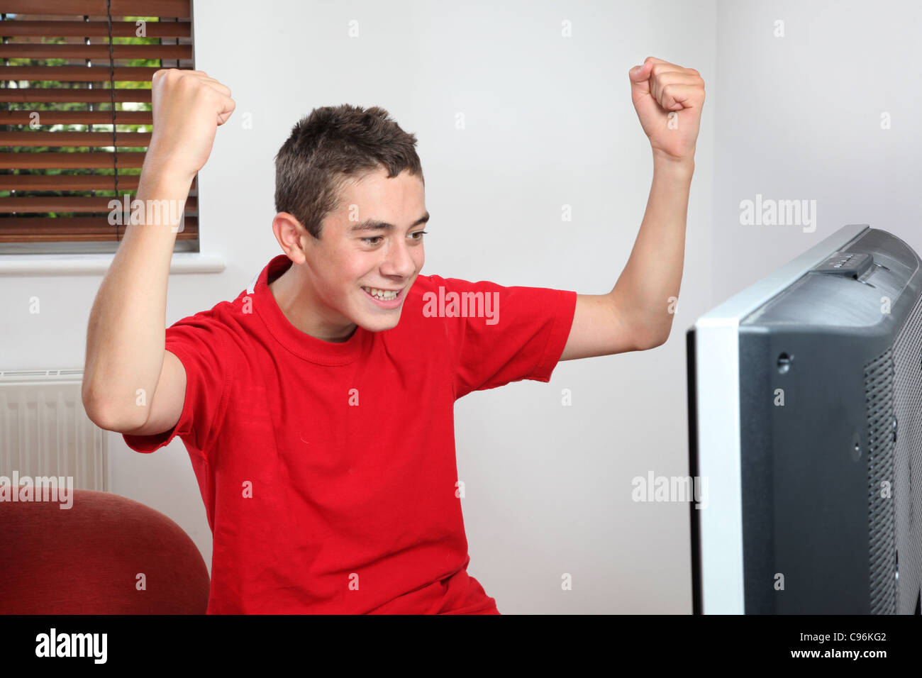 Young male watching and cheering sport on tv Stock Photo - Alamy Young male watching and cheering sport on tv Stock Photo - Alamy