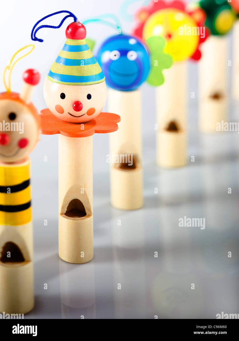 a collection of wooden kid toy whistles with different faces Stock ...