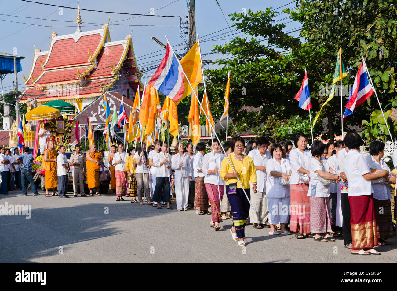 Women carrying Thai flags and golden Buddhist flags with orange ...