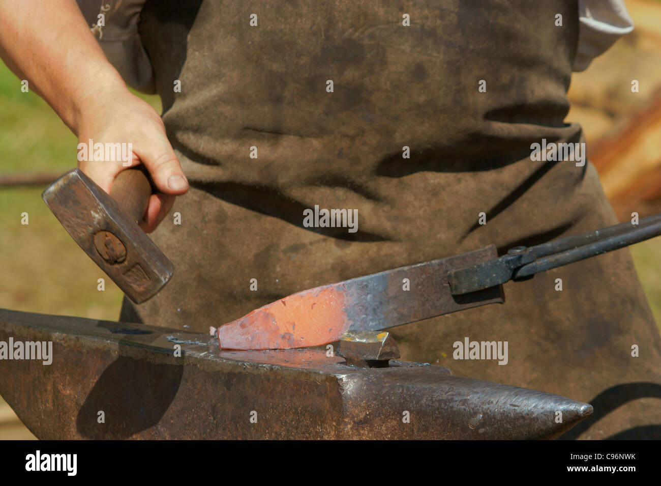 Hammering glowing steel - to strike while the iron is hot Stock Photo ...