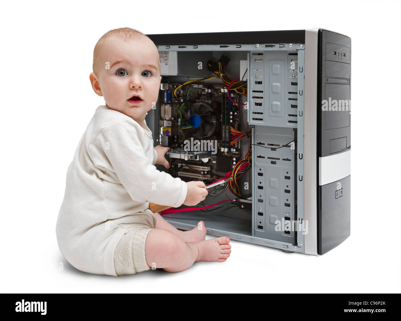 young child with screwdriver in hand working on open computer in white ...
