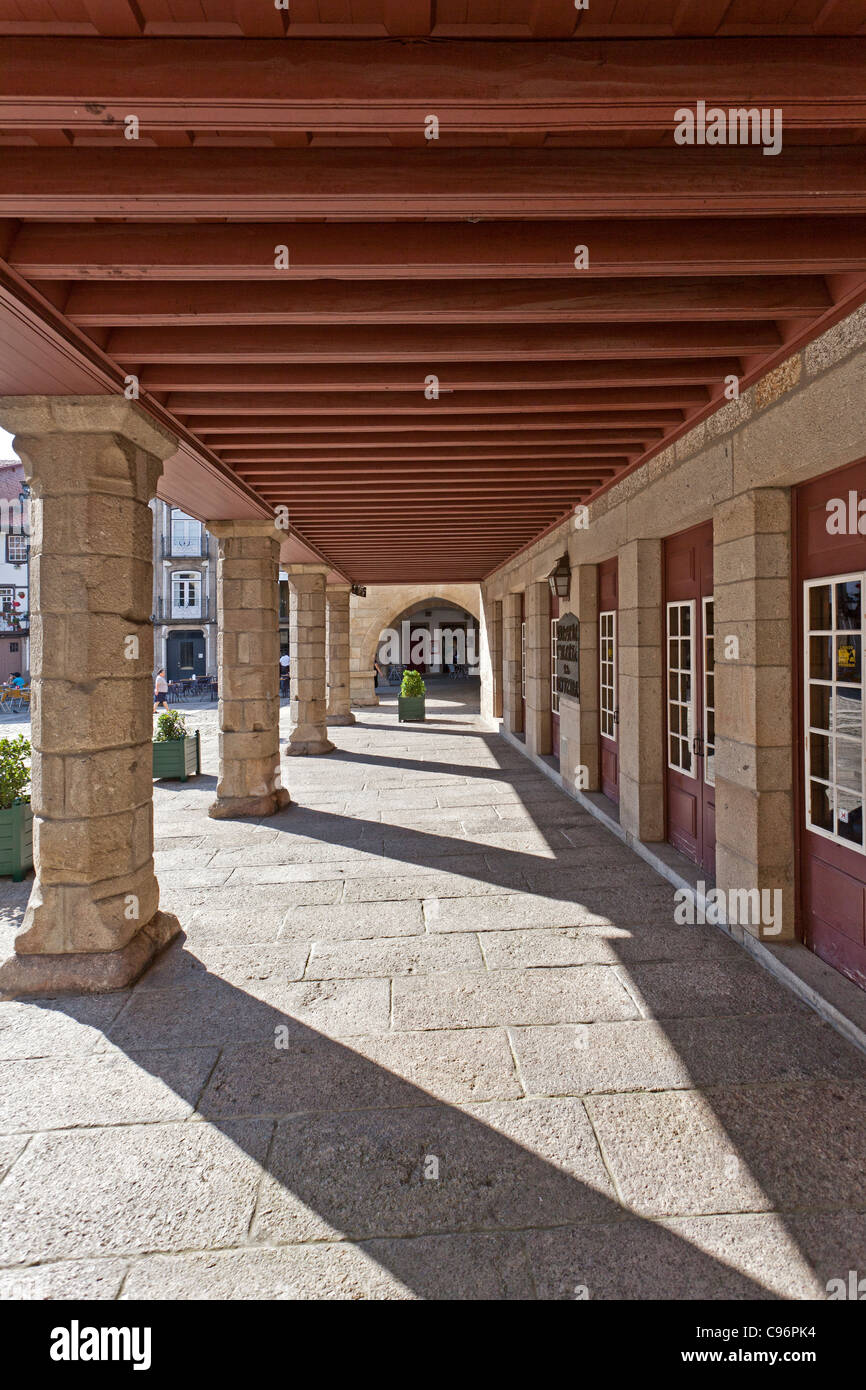 Medieval building colonnade and Oliveira Square, Guimares, Portugal ...