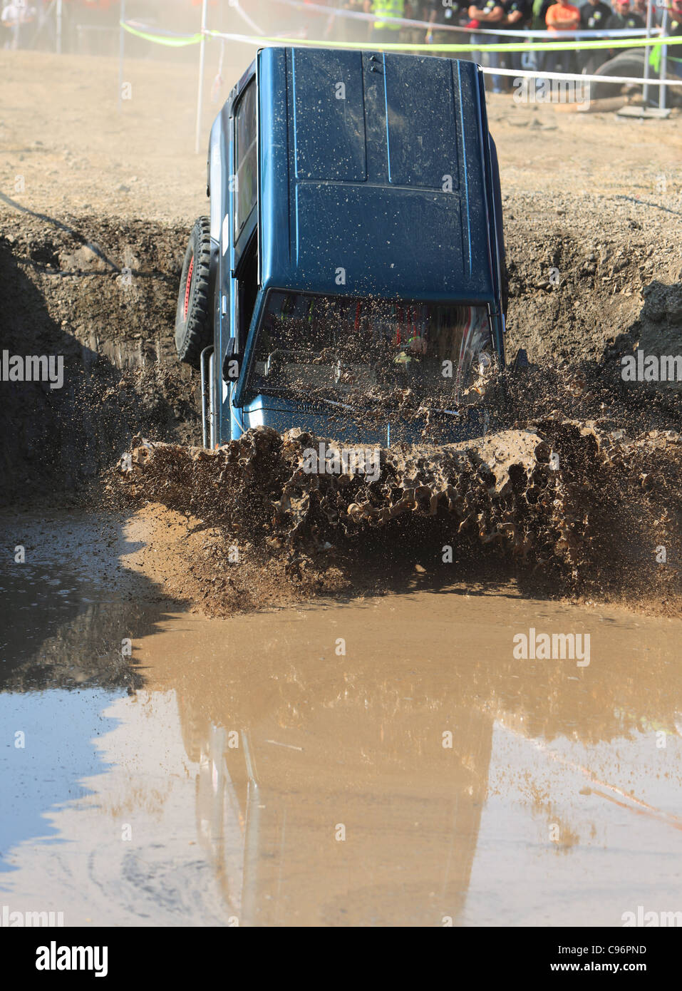 A truck during a tough off-road competition diving in a muddy pool ...