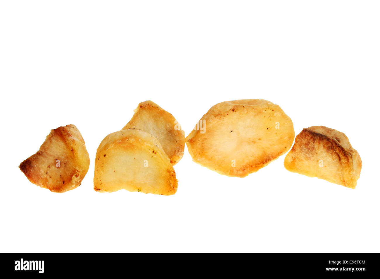 Group of roast potatoes in a line isolated against white Stock Photo ...