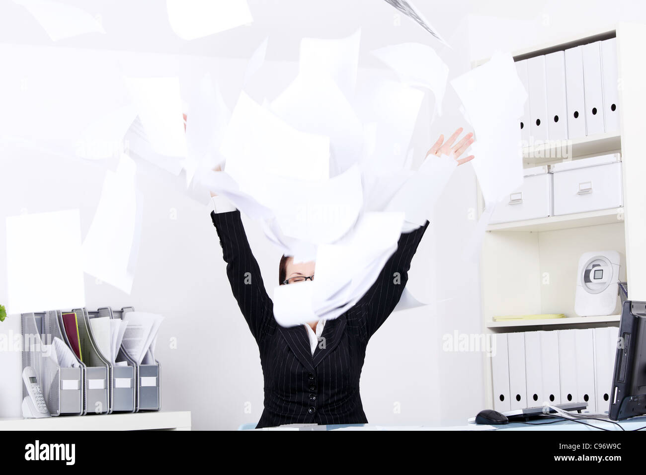 Caucasian businesswoman throwing sheets of paper in the office Stock ...