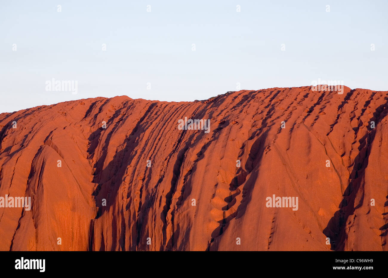 Uluru (Ayers Rock) turning deep red at sunset. Uluru-Kata Tjuta ...