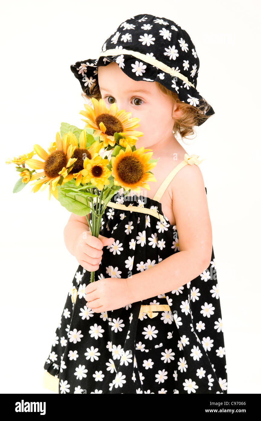 Toddler Smelling the Flowers Stock Photo - Alamy