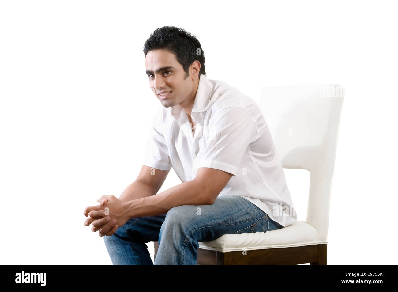 man sitting on a white chair Stock Photo - Alamy