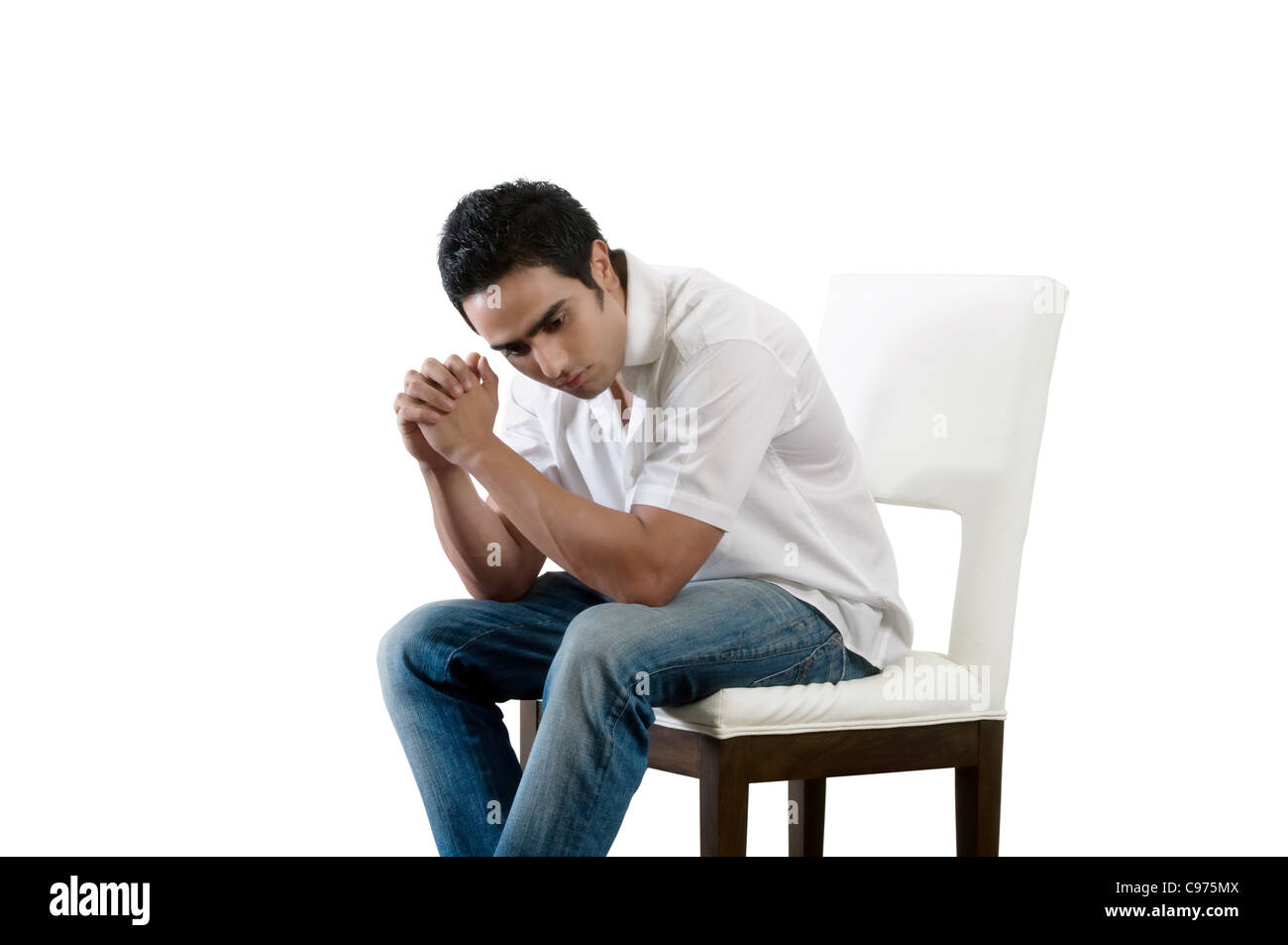 man sitting on a white chair Stock Photo - Alamy