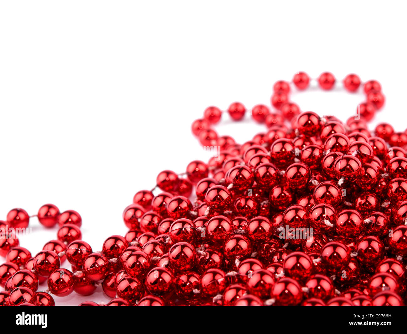 Christmas garland made from small red beads, on white background Stock ...