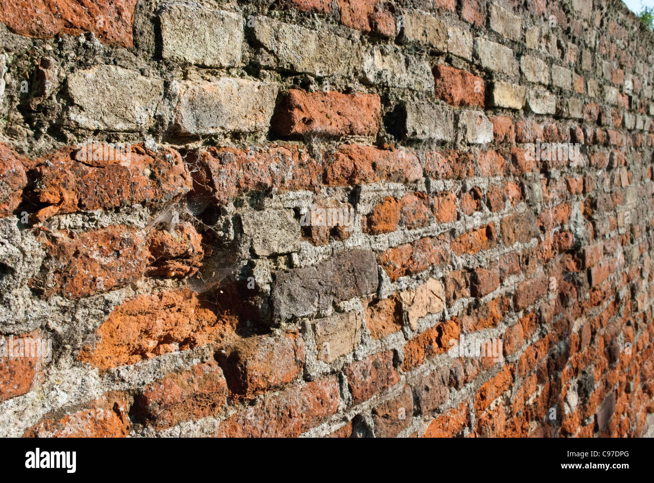 Old warn weathered red brick wall in Church Lane Ely Stock Photo - Alamy