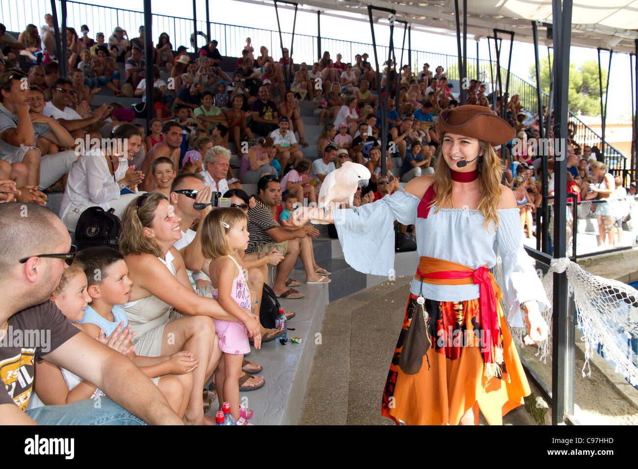 Female animal trainer presenter with parrot at parrots show in ...