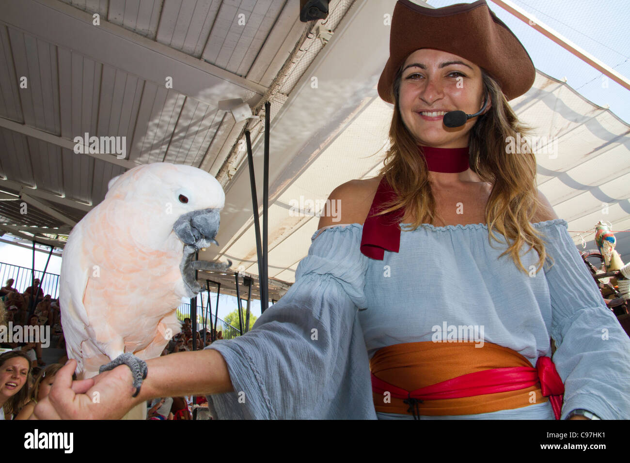 Female animal trainer presenter with parrot at parrots show in ...