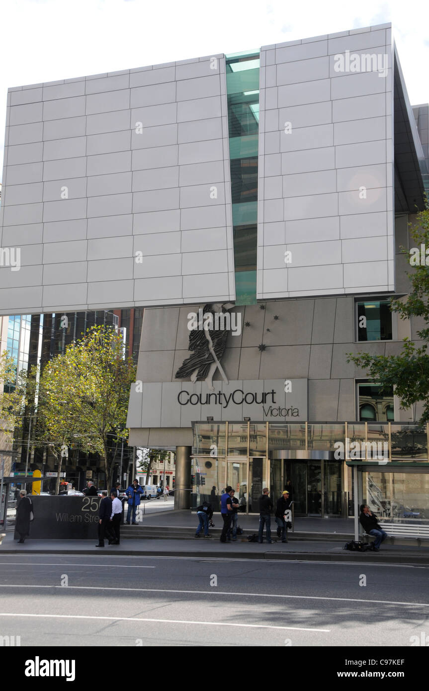 A small group of media waiting outside the County Court in Melbourne ...