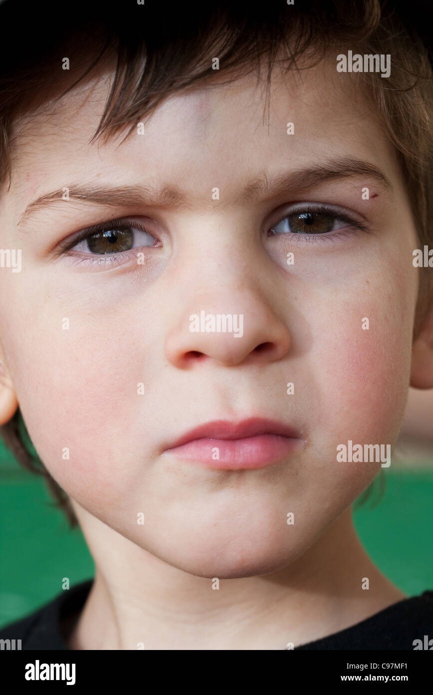 Portrait of a young boy looking serious Stock Photo - Alamy