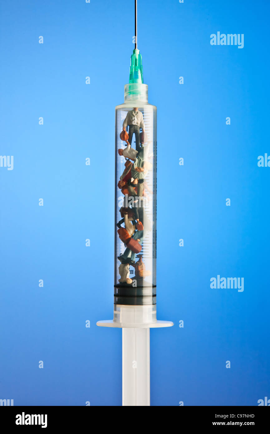 Figurines placed inside syringe Stock Photo - Alamy