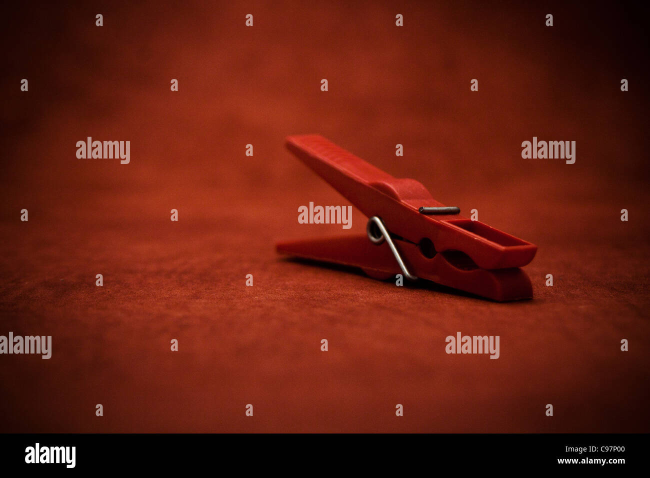 a red peg against red background Stock Photo - Alamy