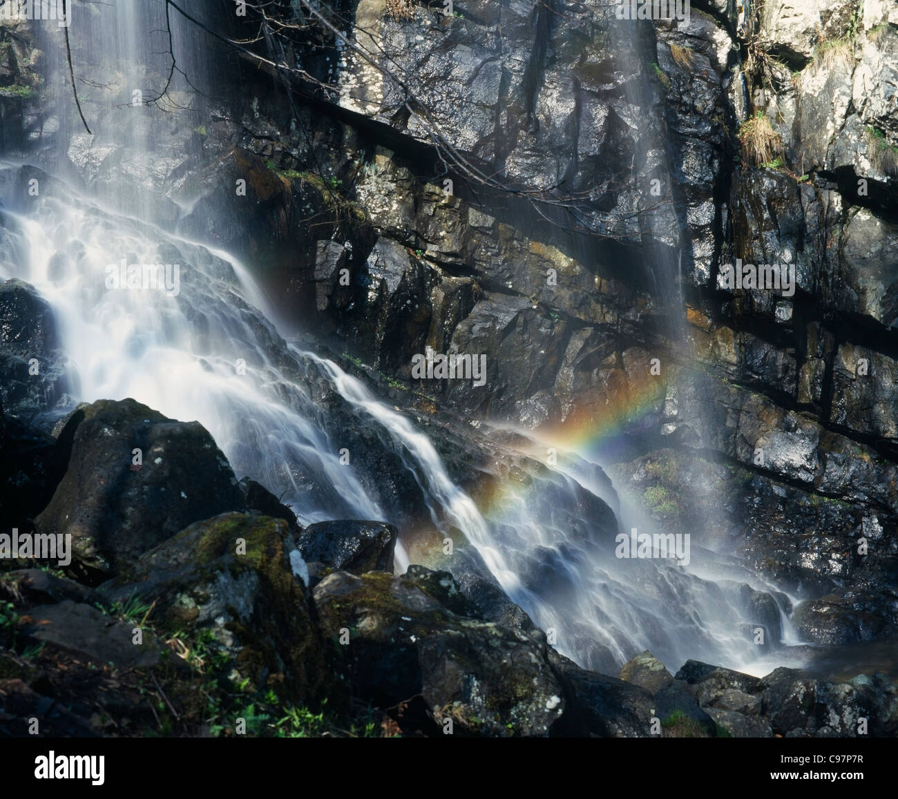 Sunny waterfall with rainbow, close up Stock Photo - Alamy
