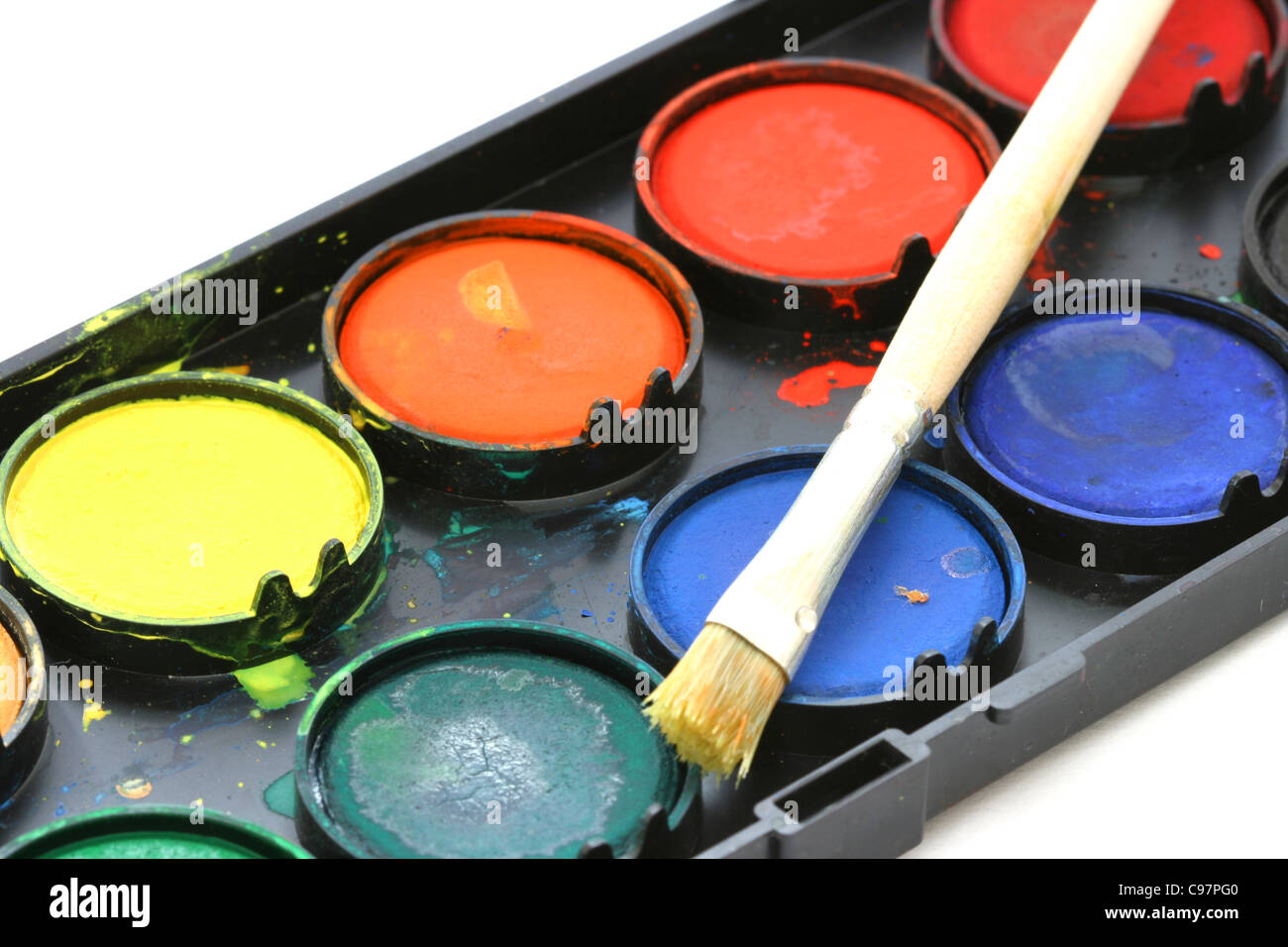 Used water color paint box with a brush close up Stock Photo - Alamy
