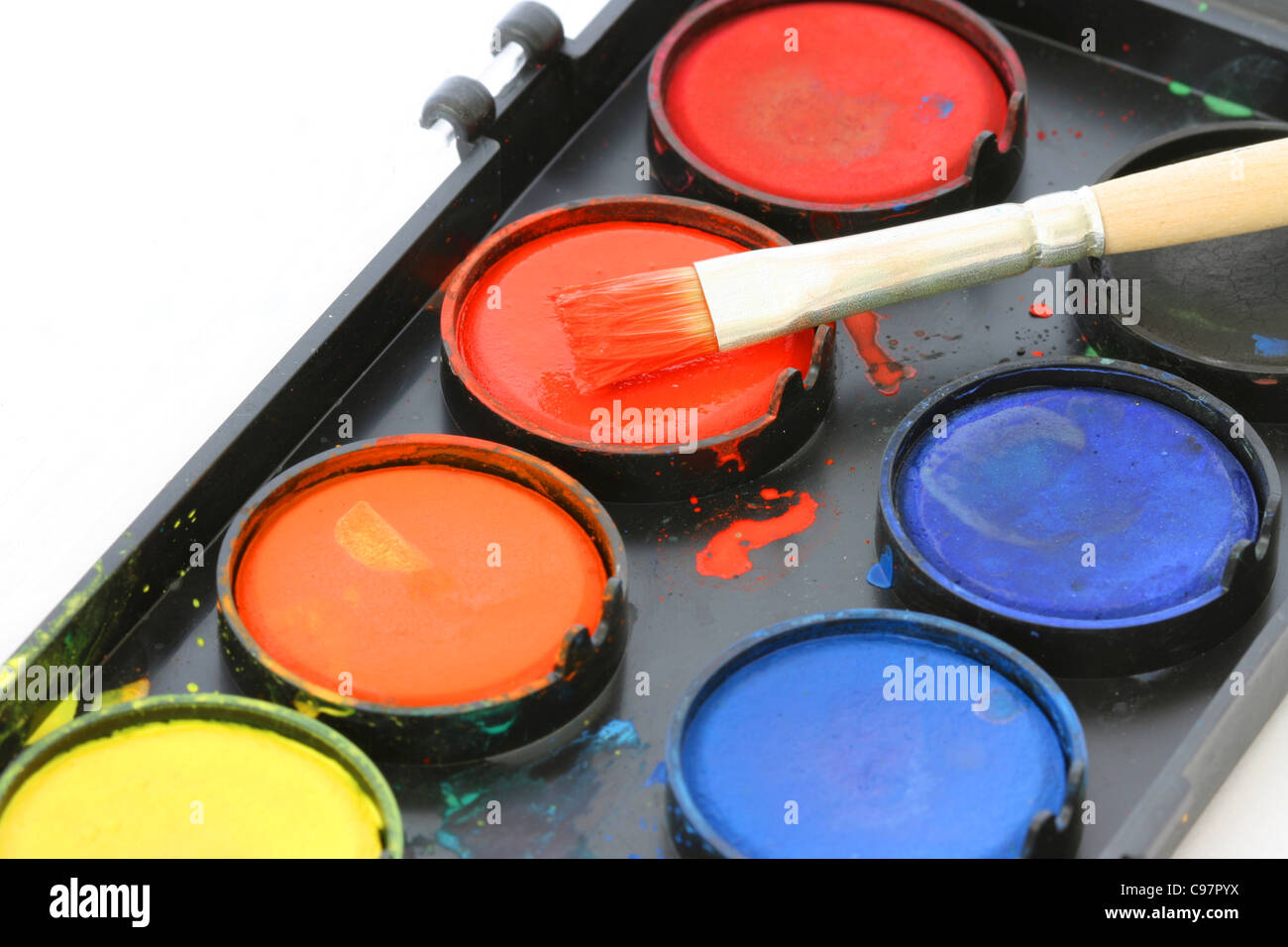 Used water color paint box with a brush close up Stock Photo - Alamy