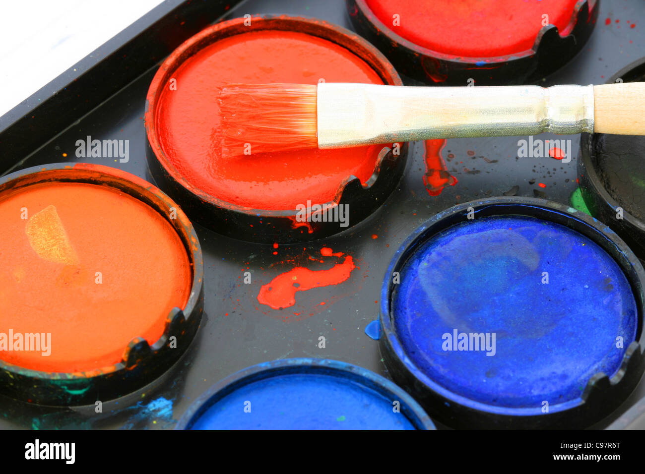 Used water color paint box with a brush close up Stock Photo - Alamy