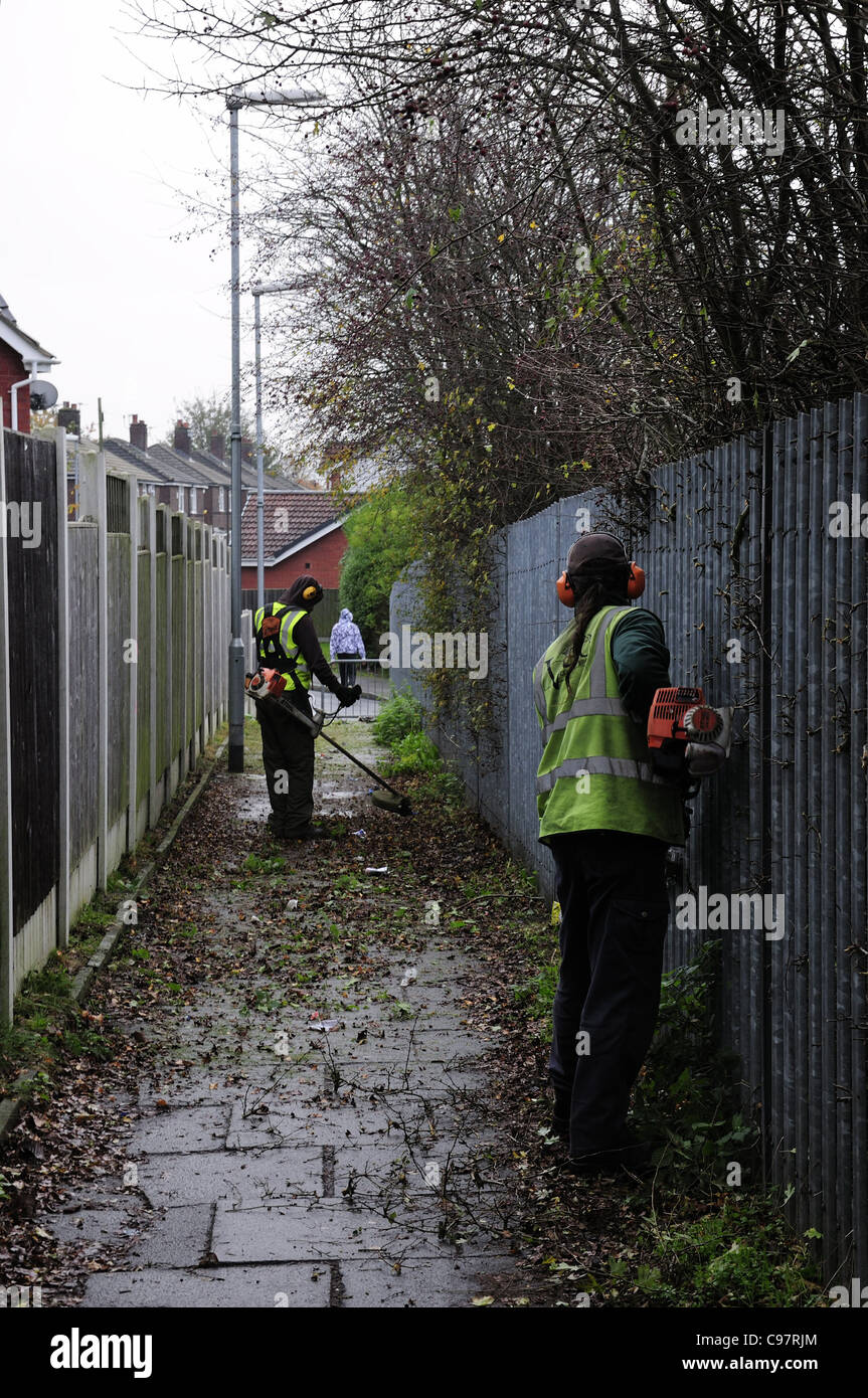 Workmen maintaining pedestrian footpath Stock Photo - Alamy