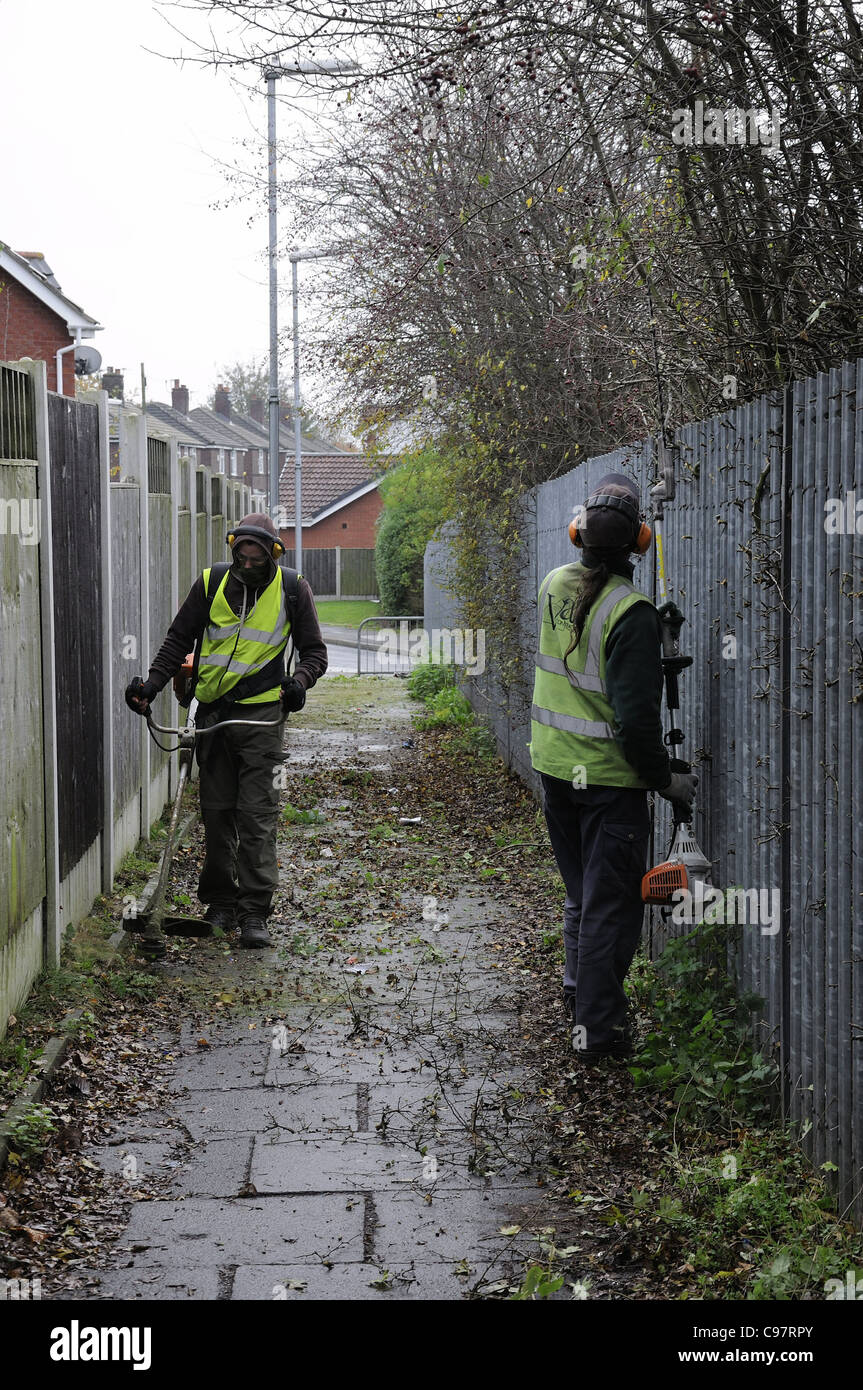 Workmen maintaining pedestrian footpath Stock Photo - Alamy