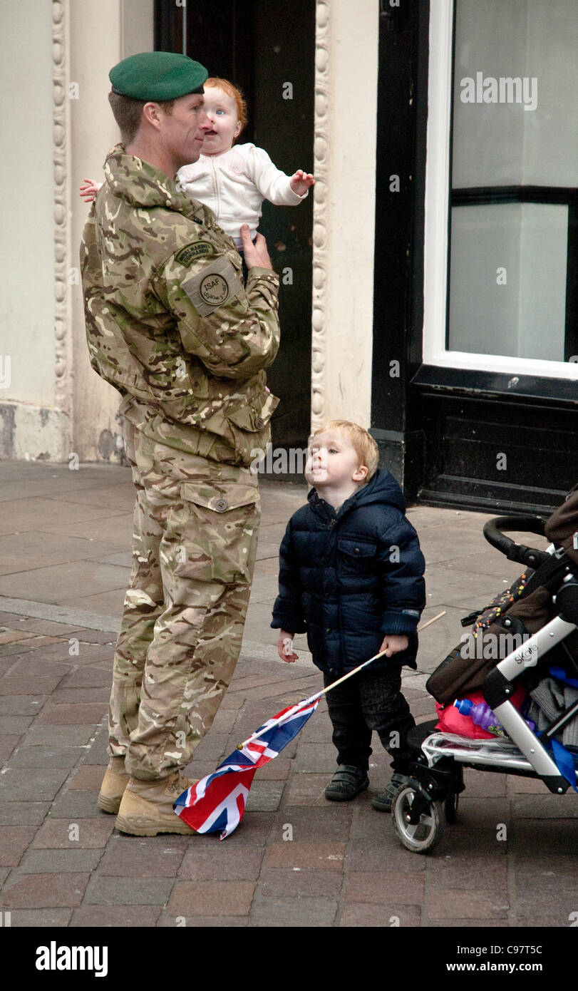 A soldier from from 3 Commando Brigade a holds one child, while the ...