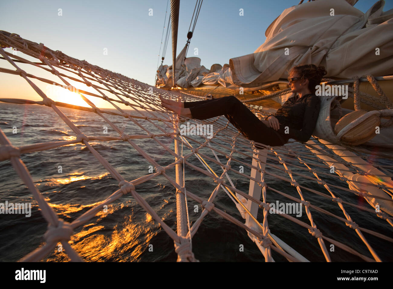 Woman relaxing in bowsprit net of sailing cruiseship Star Flyer (Star ...