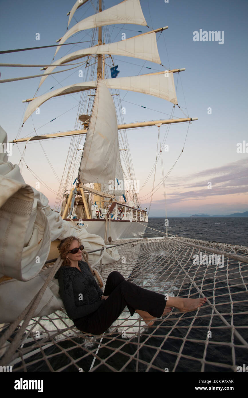 Woman relaxing in bowsprit net of sailing cruiseship Star Flyer (Star ...