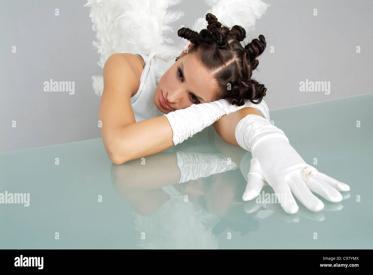 Waiting Christmas angel with a silver dress Stock Photo - Alamy