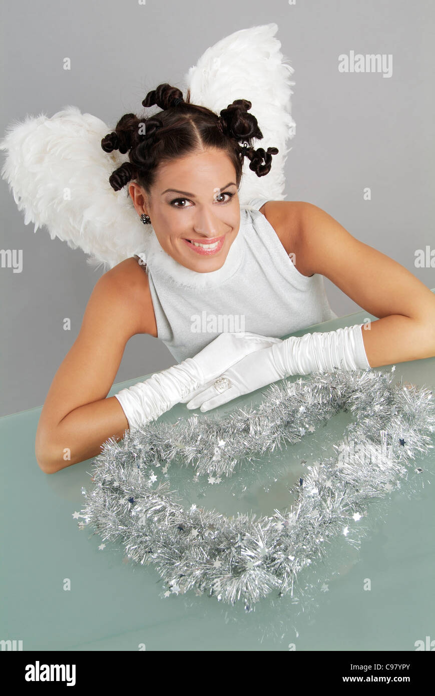 Funny Christmas angel with a silver dress and lametta Stock Photo - Alamy