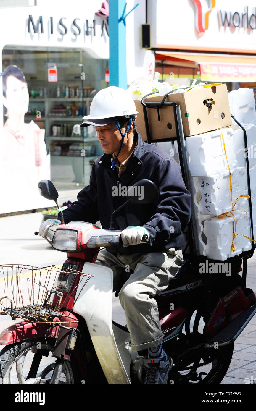 An asian man on a motorcycle in busan hi-res stock photography and ...