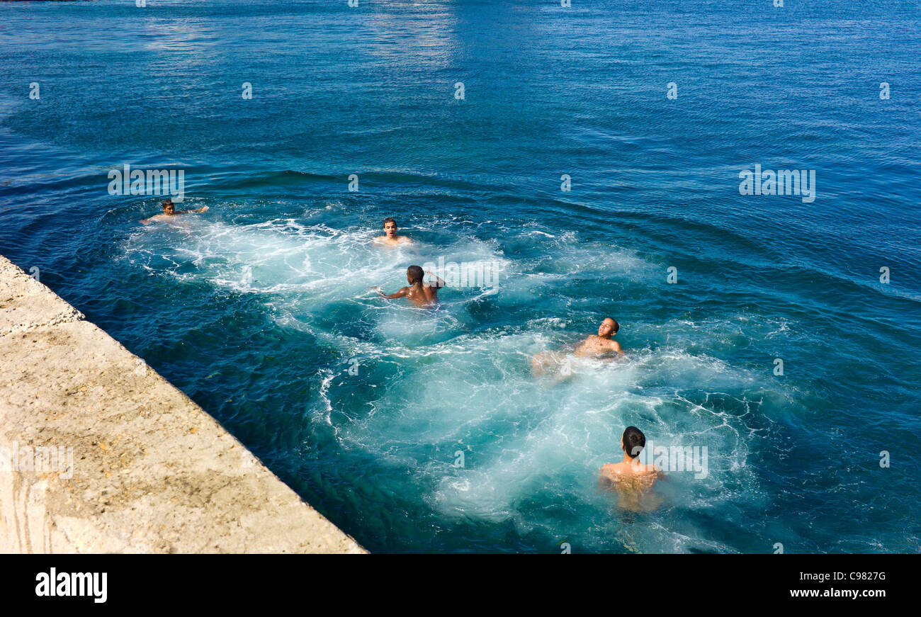 Teen boys swimming along the "Malecon" in Havana, Cuba Stock Photo - Alamy
