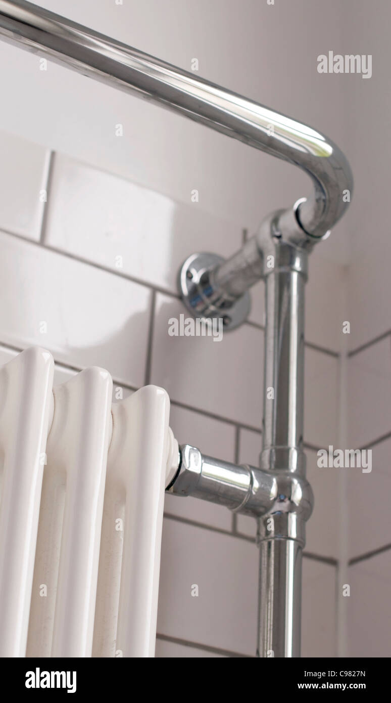 A chrome antique Victorian style radiator in a tiled bathroom Stock ...