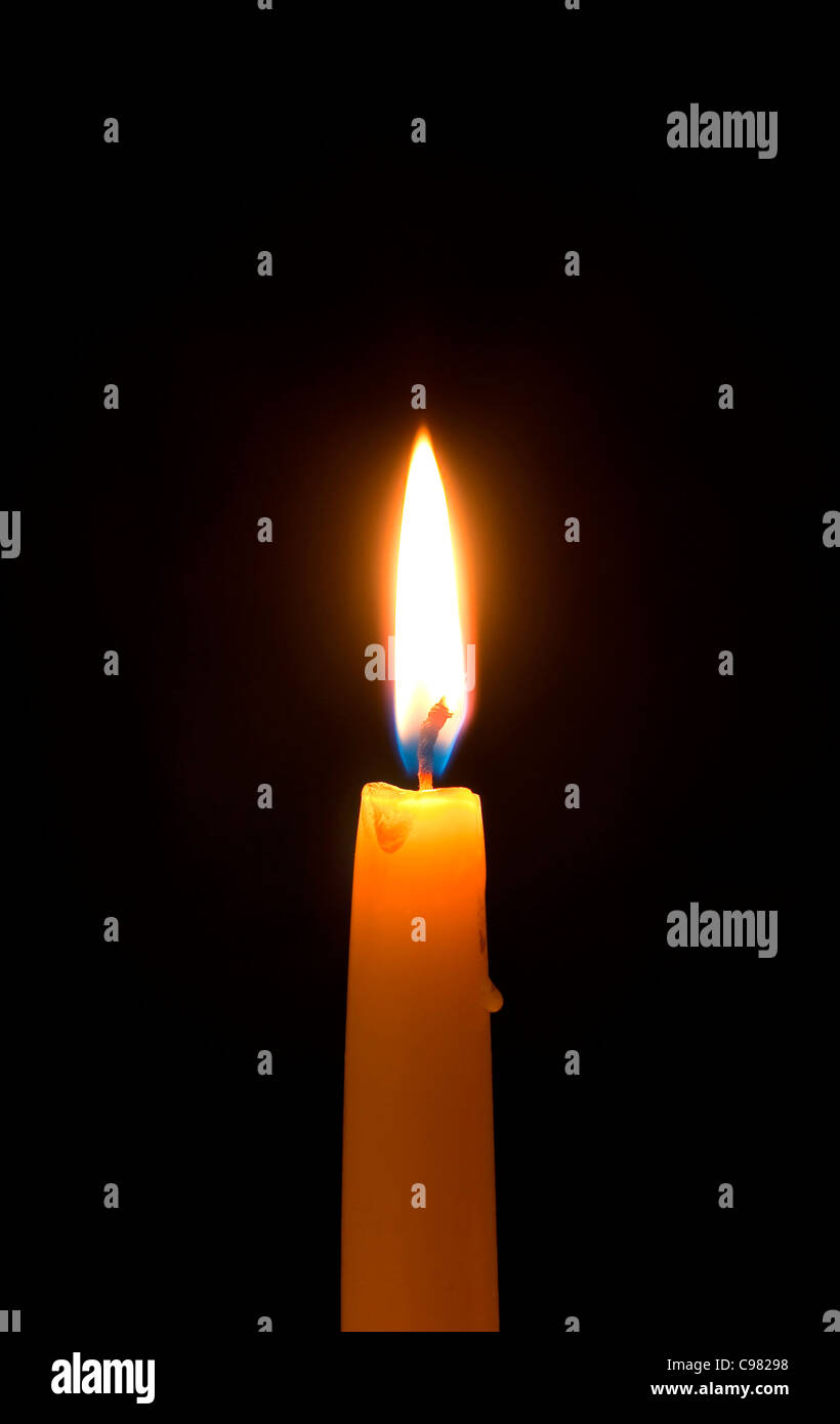 A candle isolated against black Stock Photo - Alamy