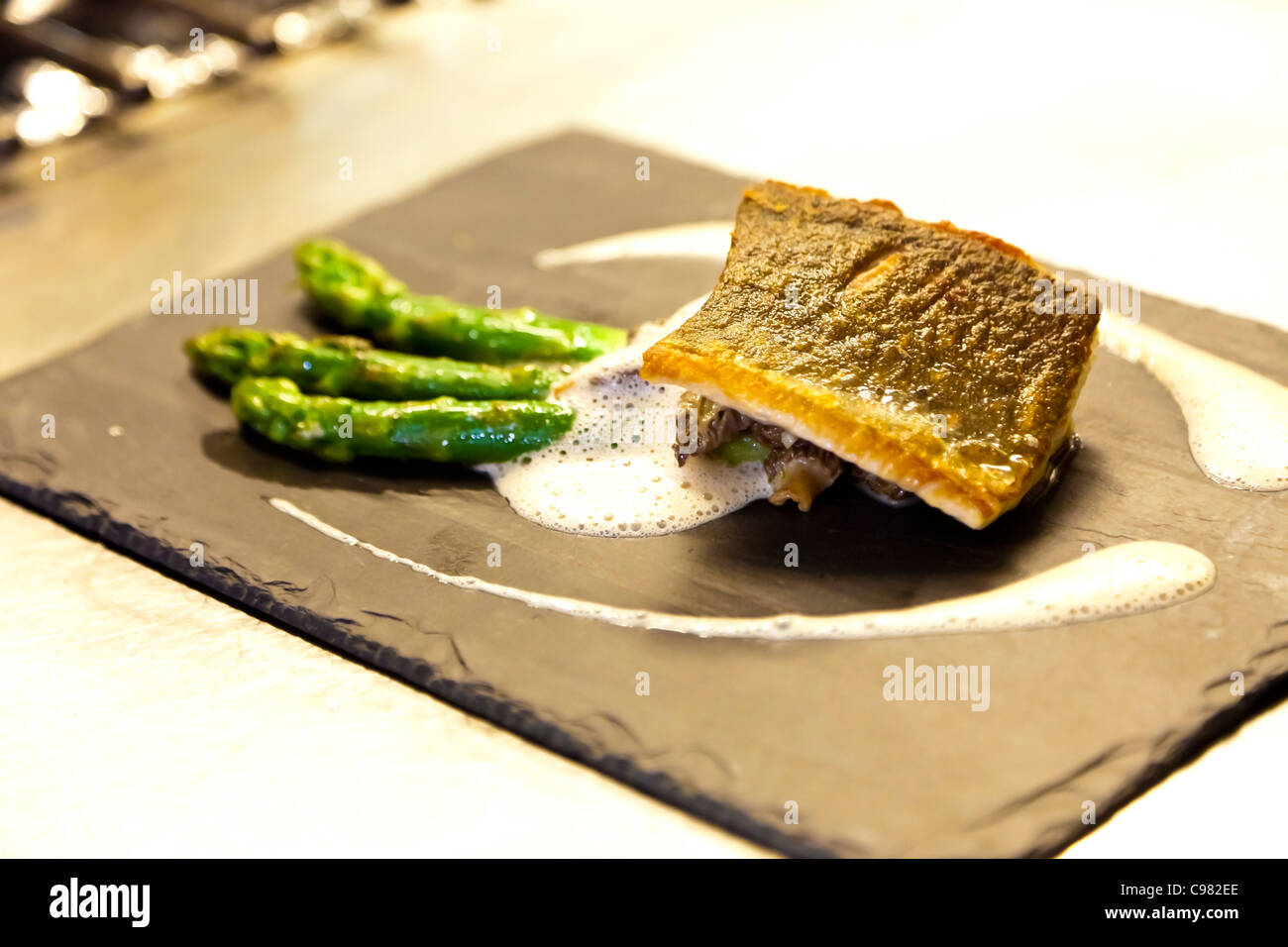 Slice of fish, asparagus and morels with a special sauce., Restaurant ...