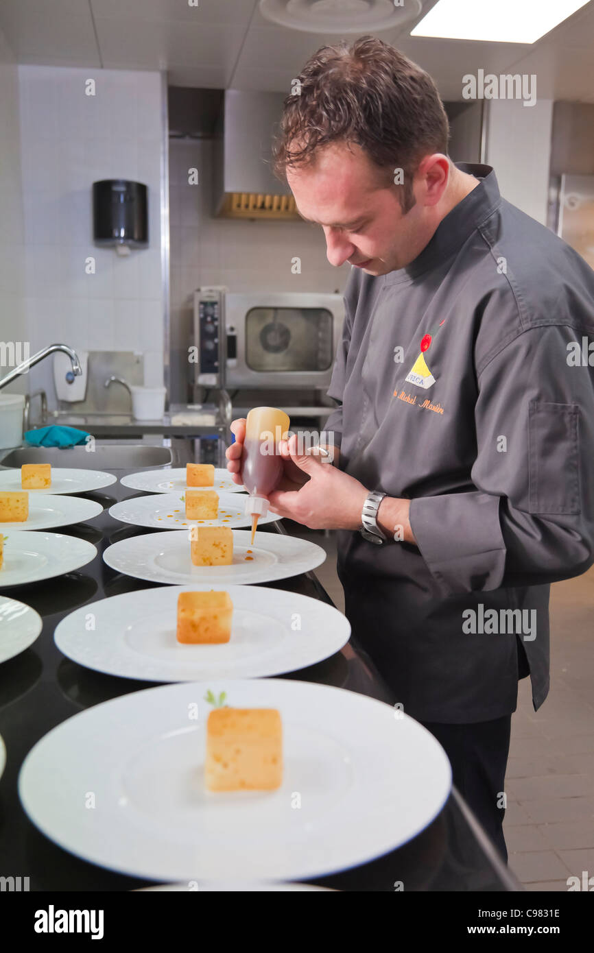 Jean-Michel Maniere, the head pastry chef garnishing and preparing one ...