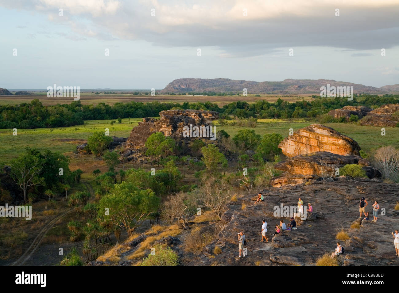 Tourists watching sunset at the sacred Aboriginal site of Ubirr. Kakadu National Park, Northern ...