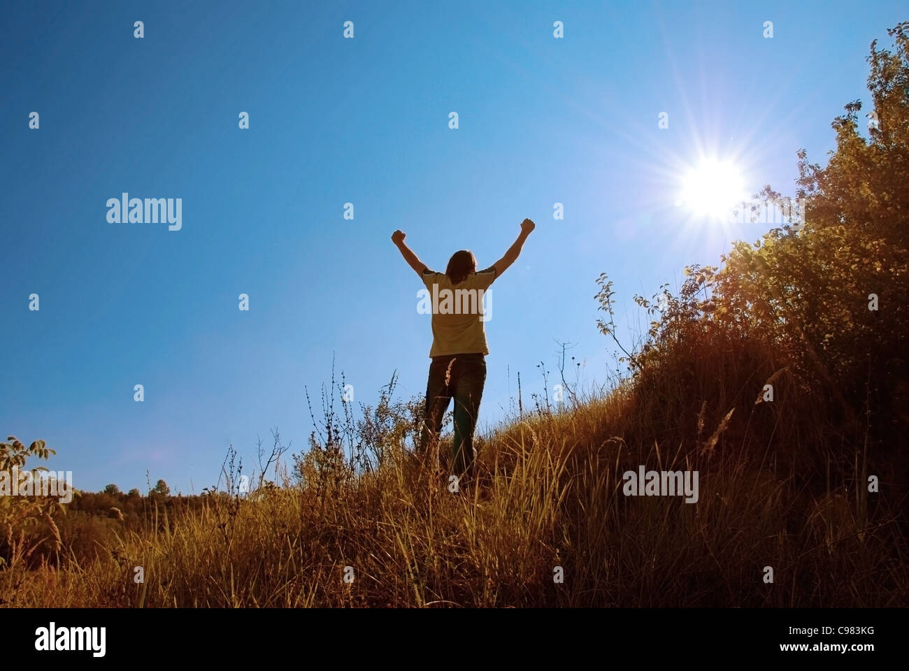 Picture of a man raising his hands as a sign of victory Stock Photo - Alamy