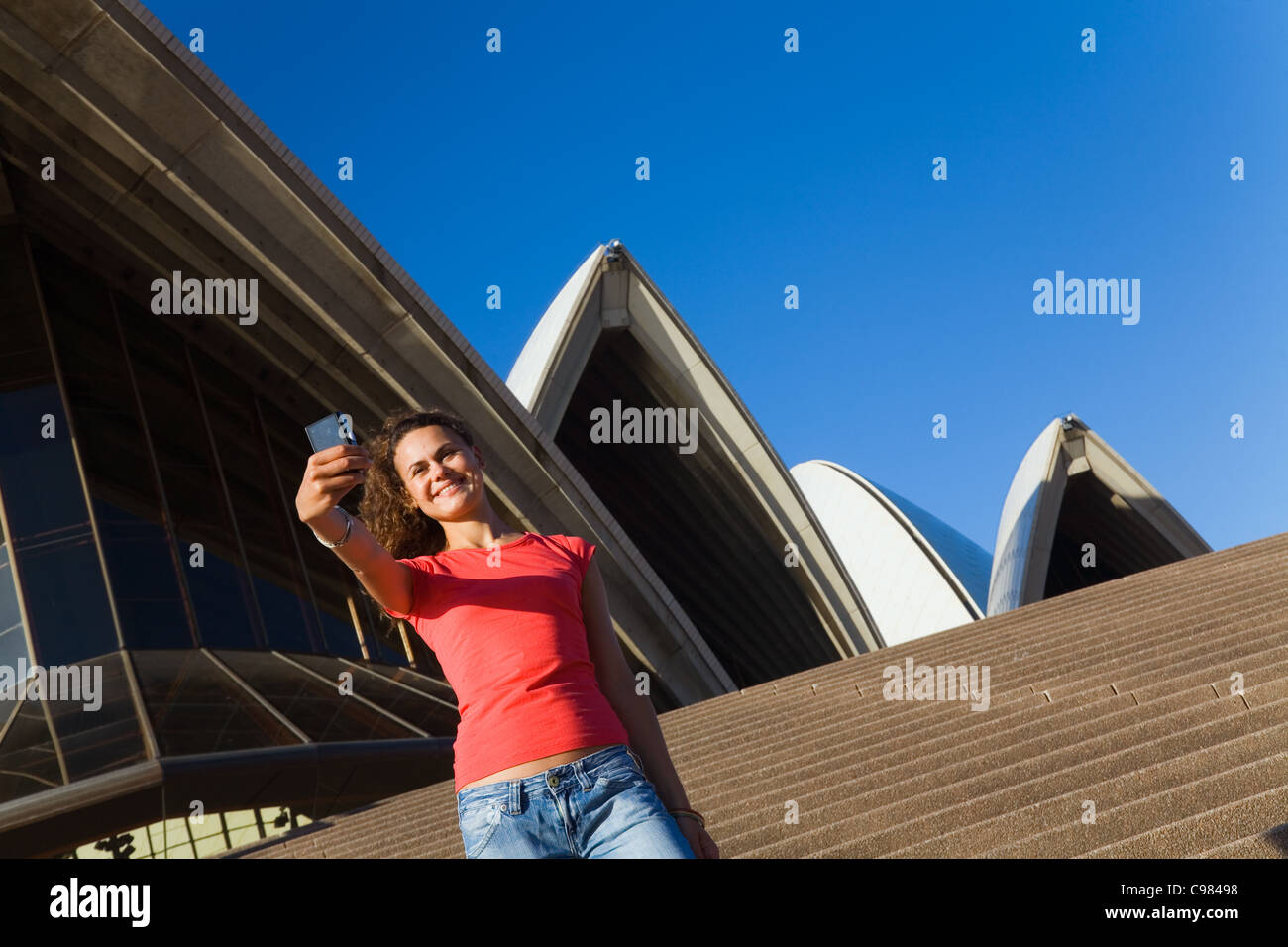 Tourist taking self portrait on steps of Sydney Opera House. Sydney ...