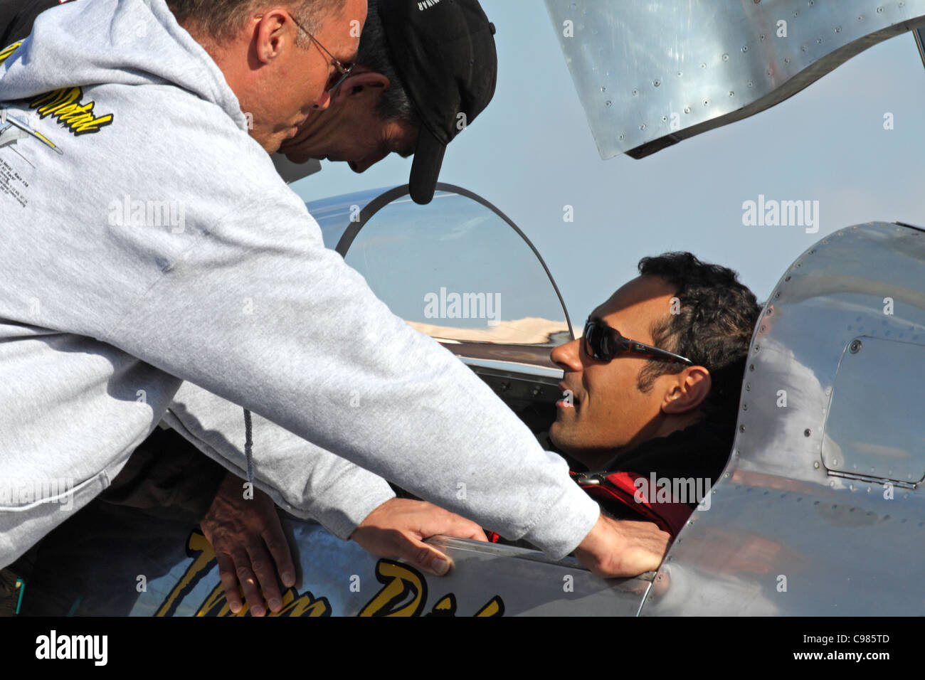 Crew members of the P-51 Air Racer 'Precious Metal' discuss strategy ...