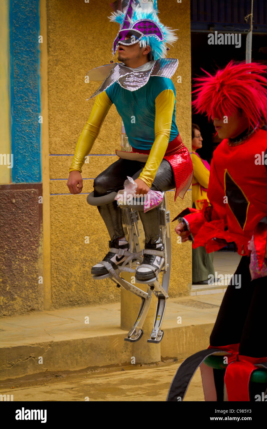 Acrobats on bouncing stilts entertain the crowds in a street parade in ...