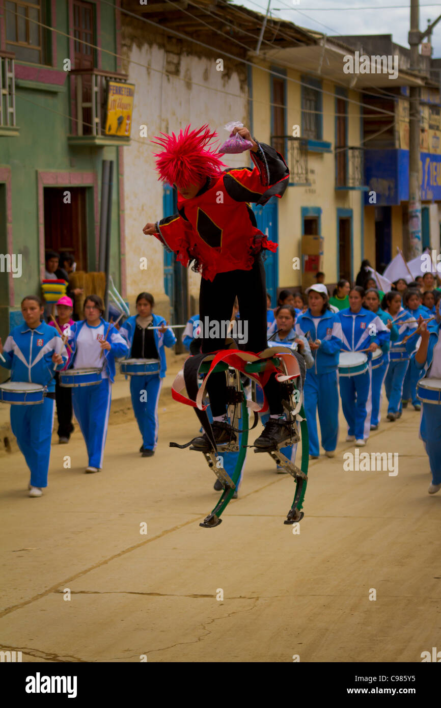 Acrobats on bouncing stilts entertain the crowds in a street parade in ...
