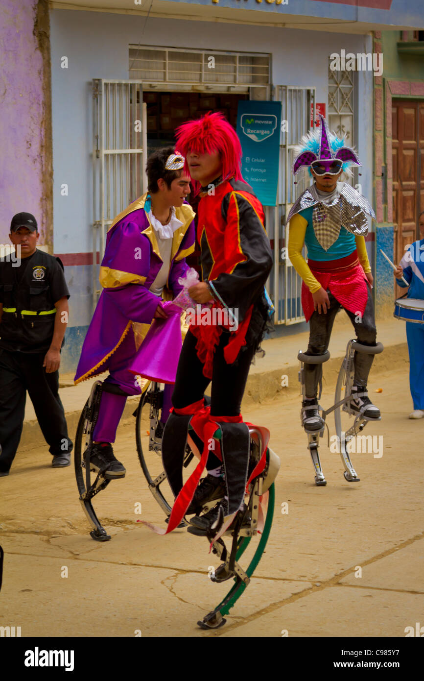 Acrobats on bouncing stilts entertain the crowds in a street parade in ...