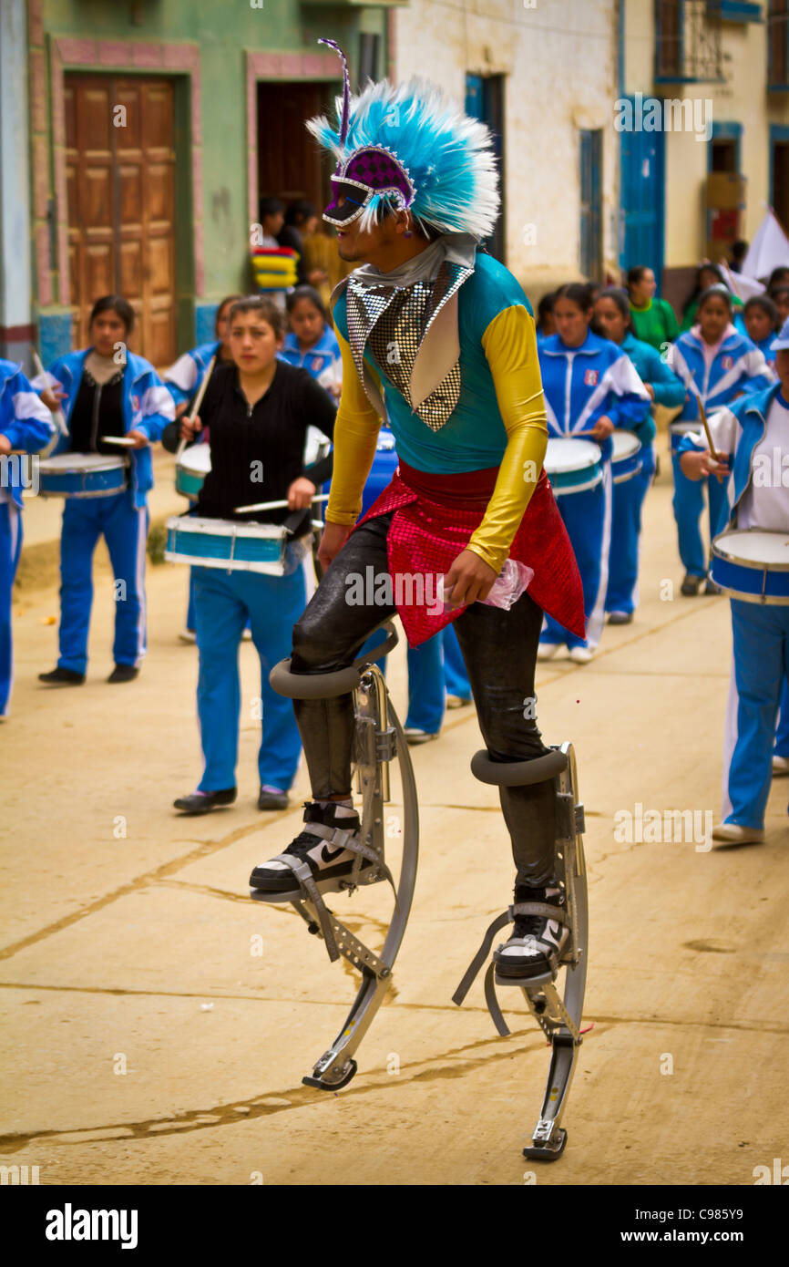 Acrobats on bouncing stilts entertain the crowds in a street parade in ...
