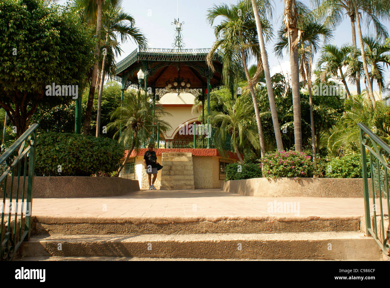 Tourist crossing the main plaza in the town of El Quelite near Mazatlan ...