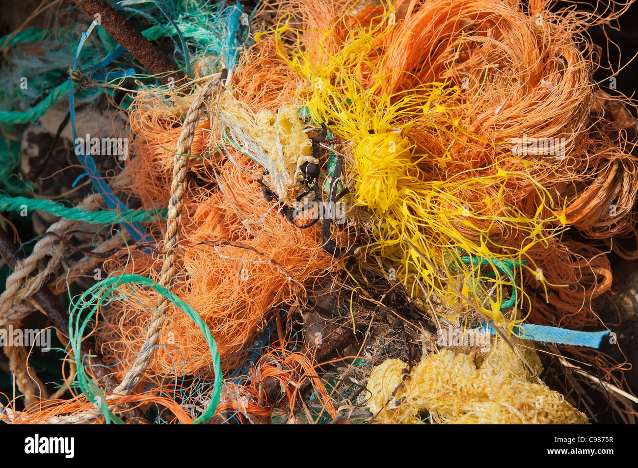 mass of weathered nylon ropes and fishing nets caught on a groin Stock ...