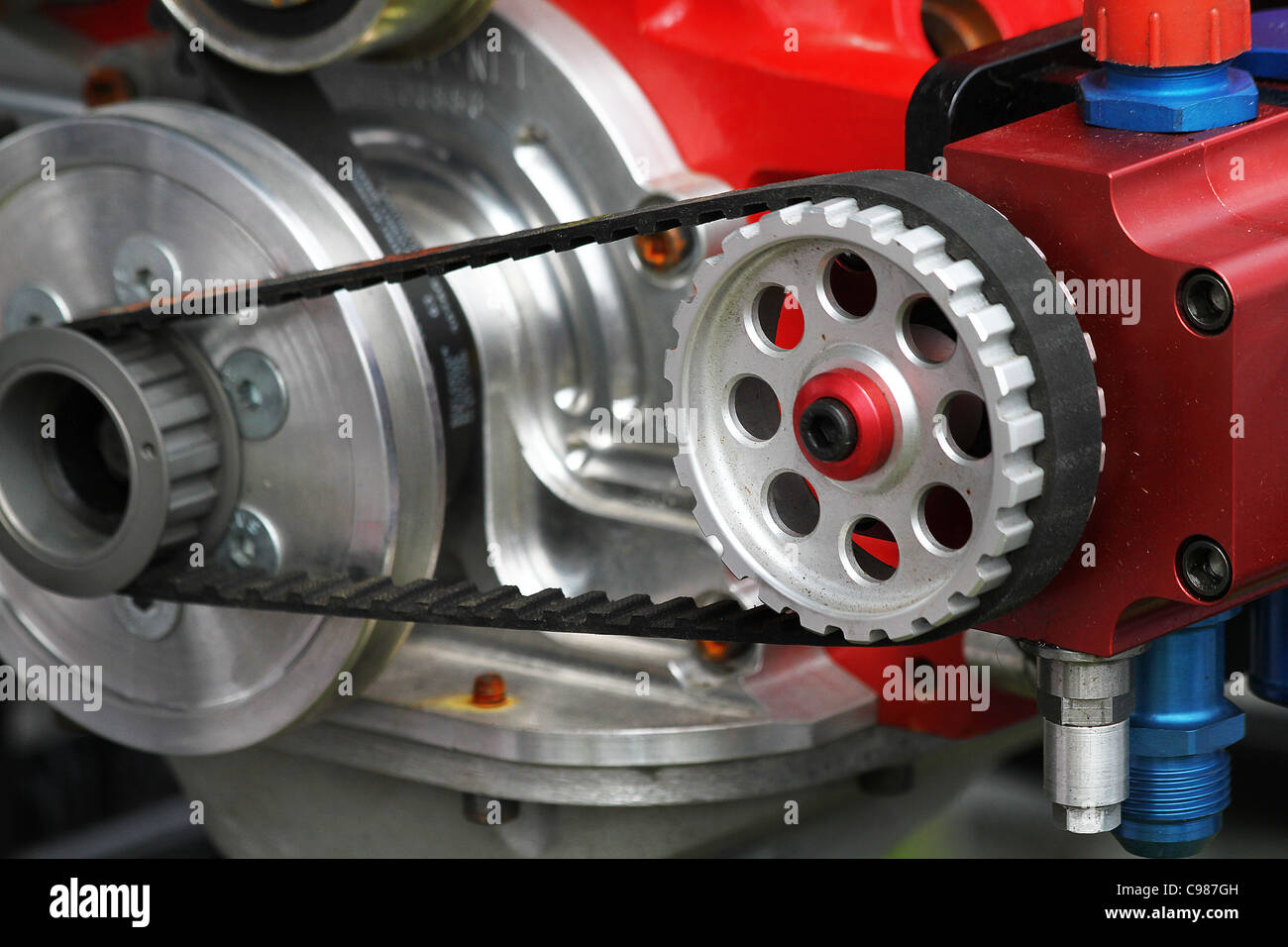 Rubber drive belt and cogs on engine Stock Photo - Alamy
